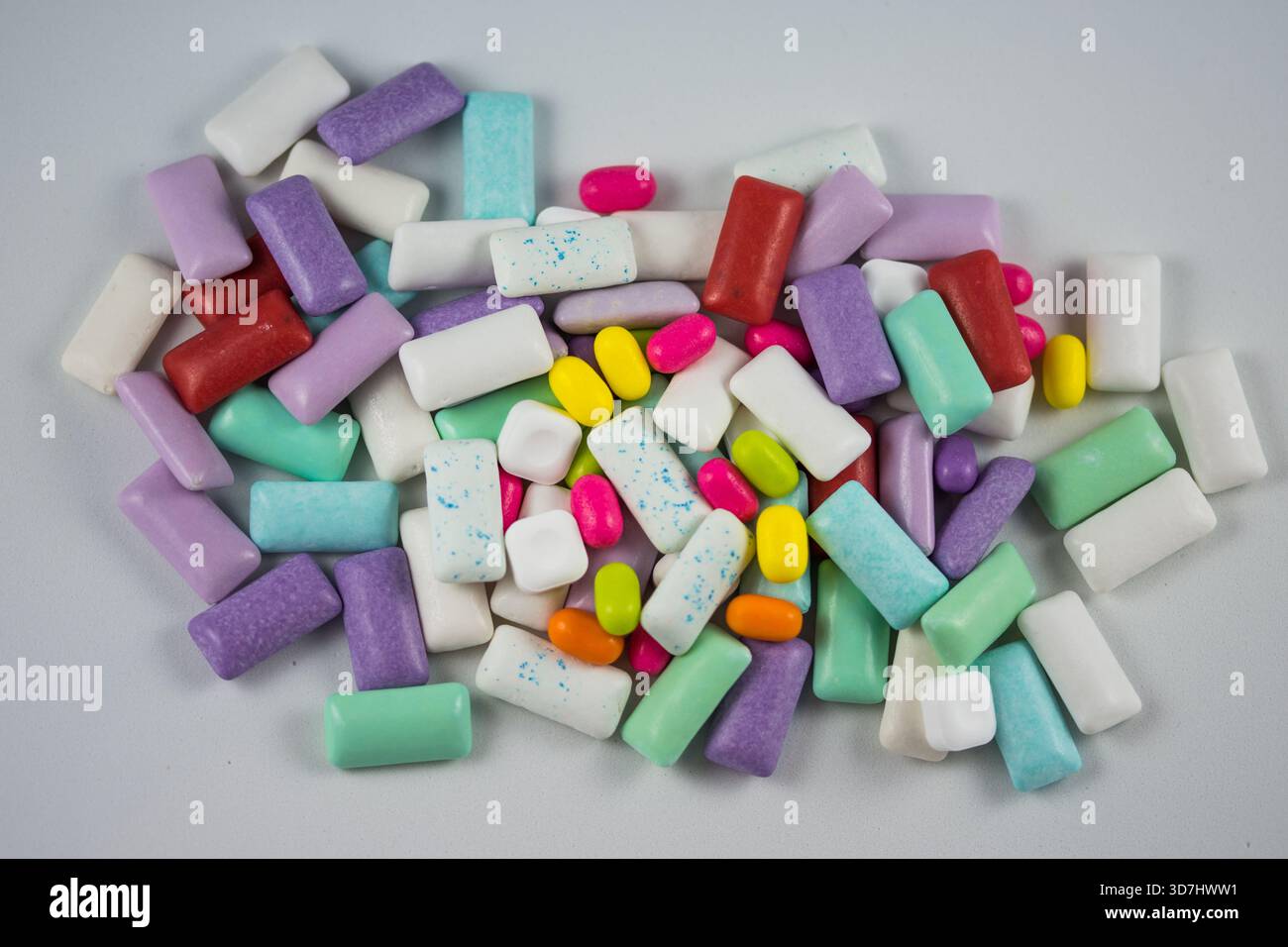 a pile of assorted, colorful chewing gum pieces. Chewing gum is a soft ...