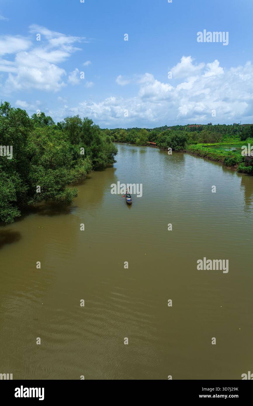 A local fisherman in the Cumbarjua Canal, Goa, India. The Cumbarjua ...