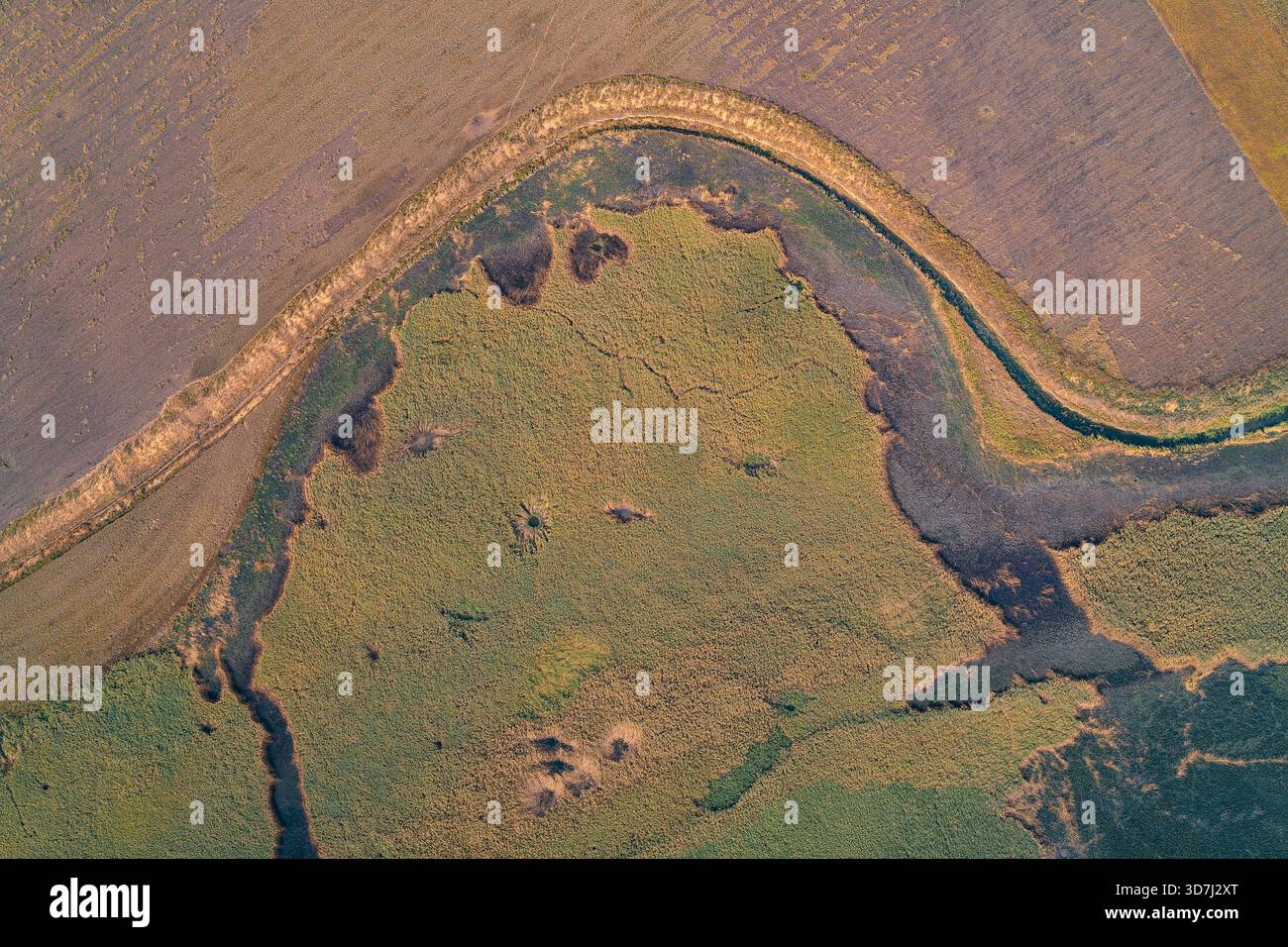Aerial drone shot showing a curved anti-tank ditch forming a military ...