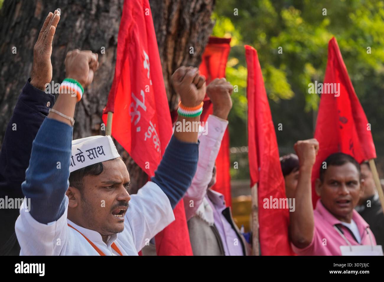 Members of various Indian trade unions shout slogans during a protest ...