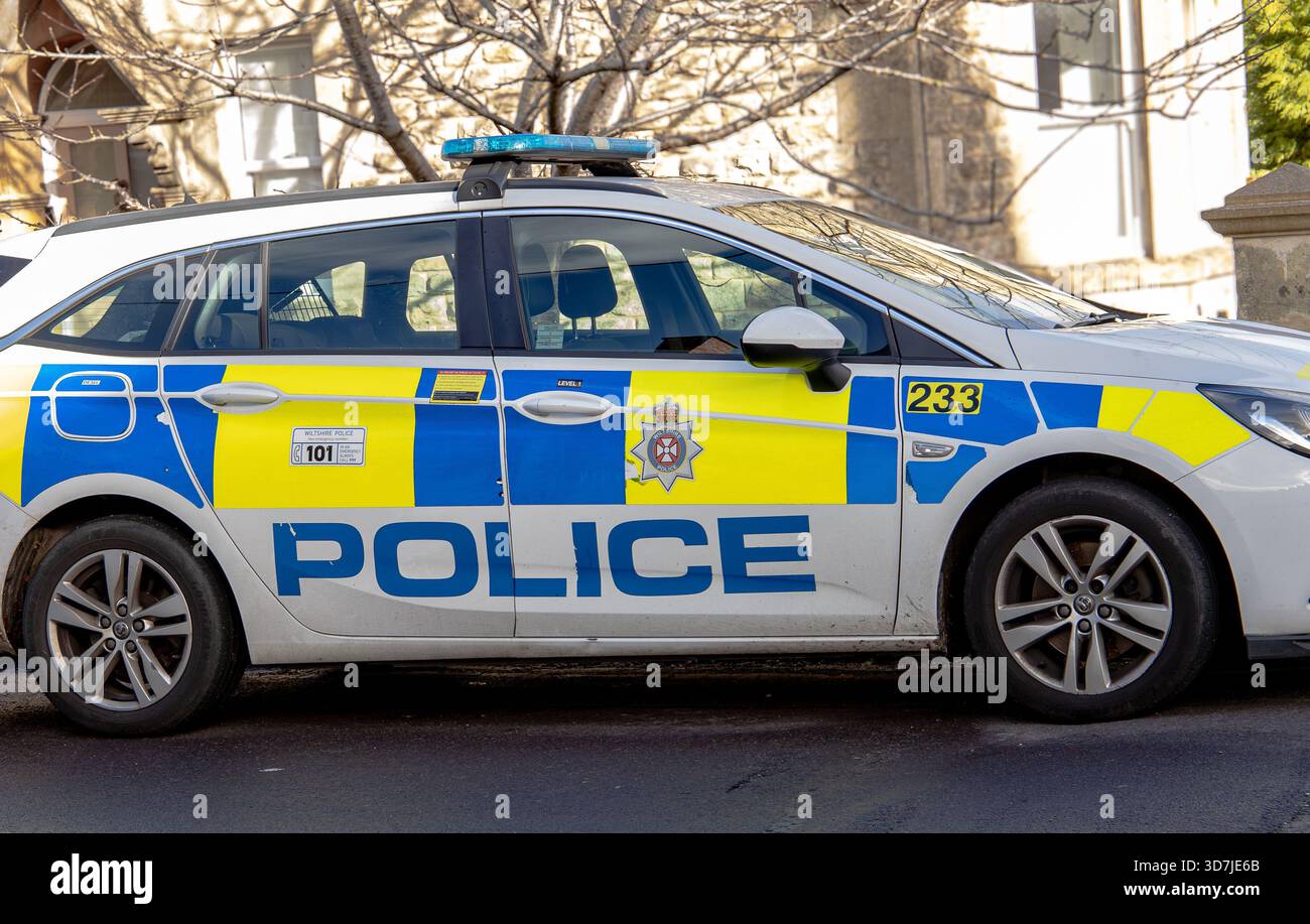 Side view of a marked Wiltshire UK police car with blue and yellow ...
