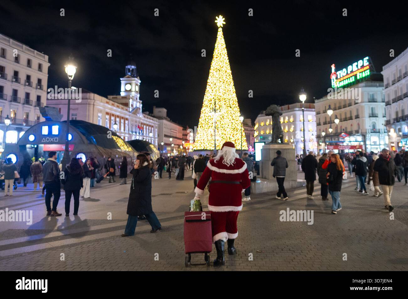 A man dressed as Santa Claus walks near the Christmas tree in Sol ...
