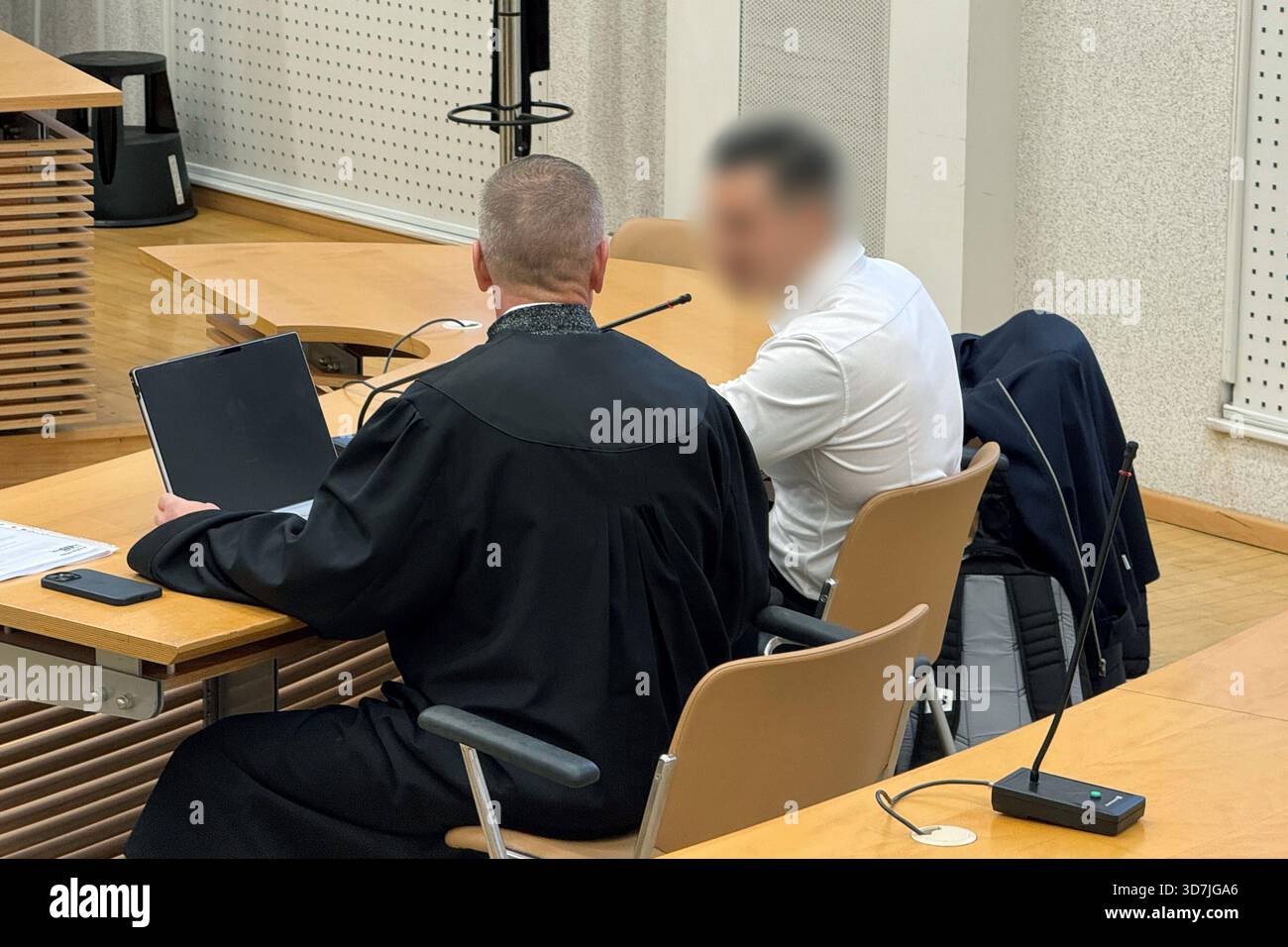 26 November 2025, Baden-Württemberg, Mannheim: The defendant (r) sits ...