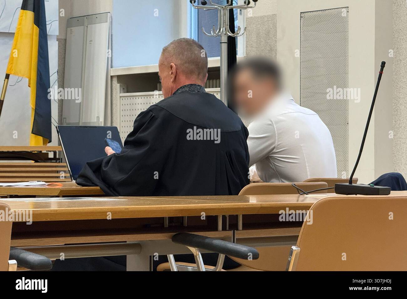 26 November 2025, Baden-Württemberg, Mannheim: The defendant (r) sits ...
