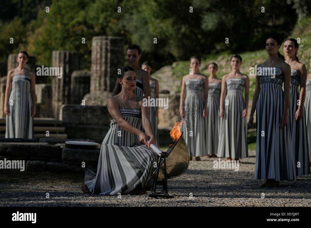 Actress Mary Mina, playing a priestess, lights the flame during a ...