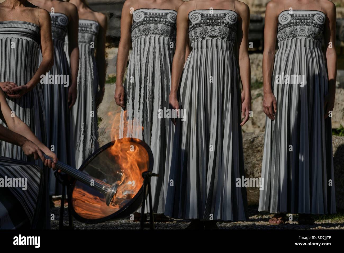 Actress Mary Mina, playing a priestess, lights the flame during a ...