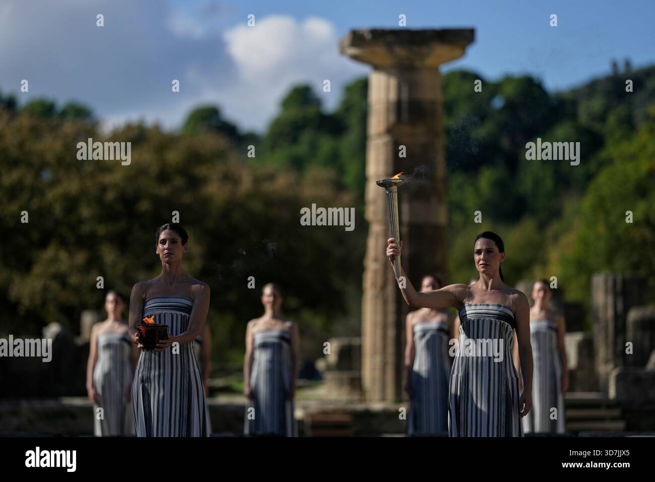 Actress Mary Mina, playing the high priestess holds a pot with the ...