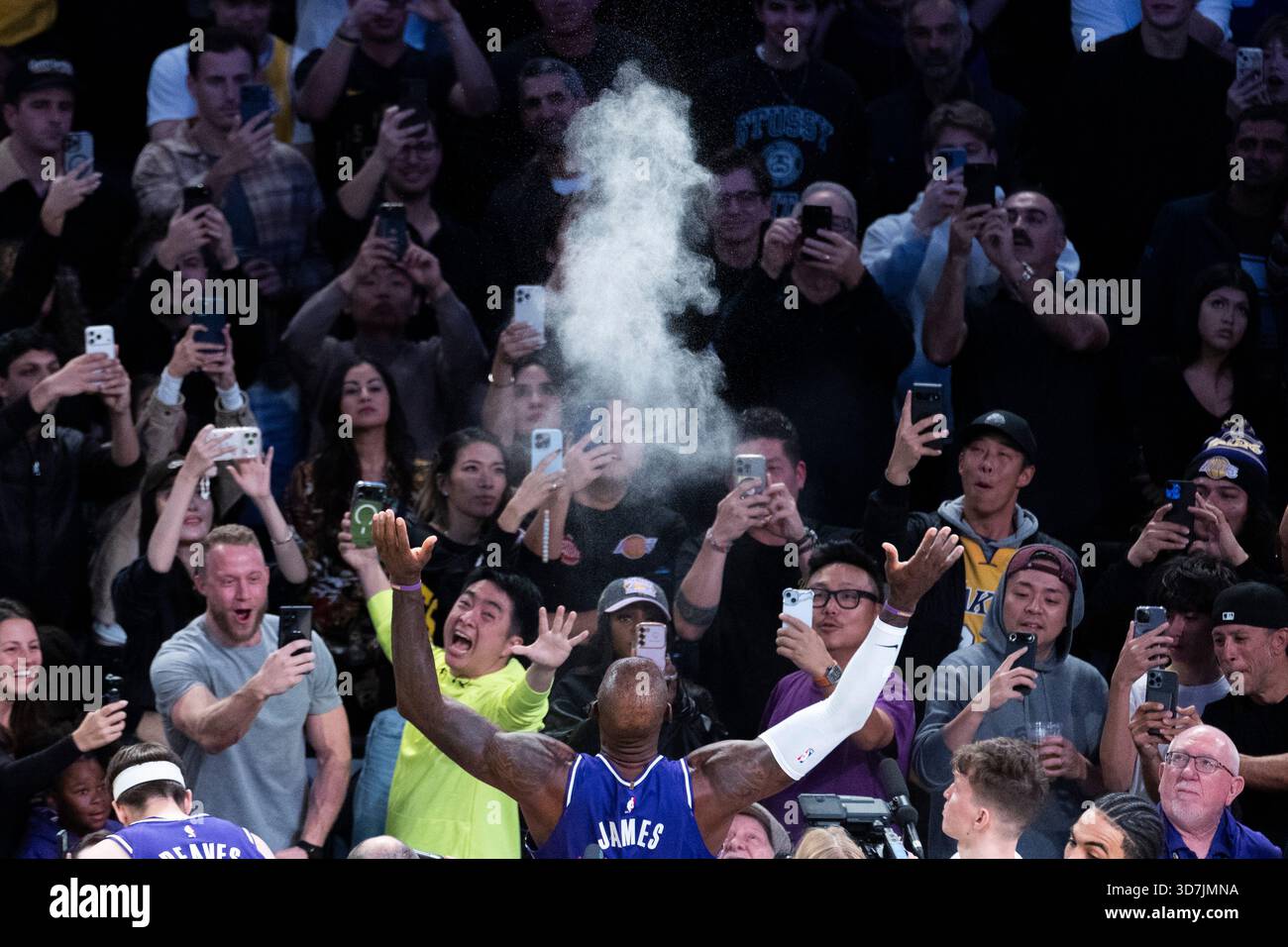 Los Angeles Lakers’ LeBron James (23) tosses powder before an NBA ...