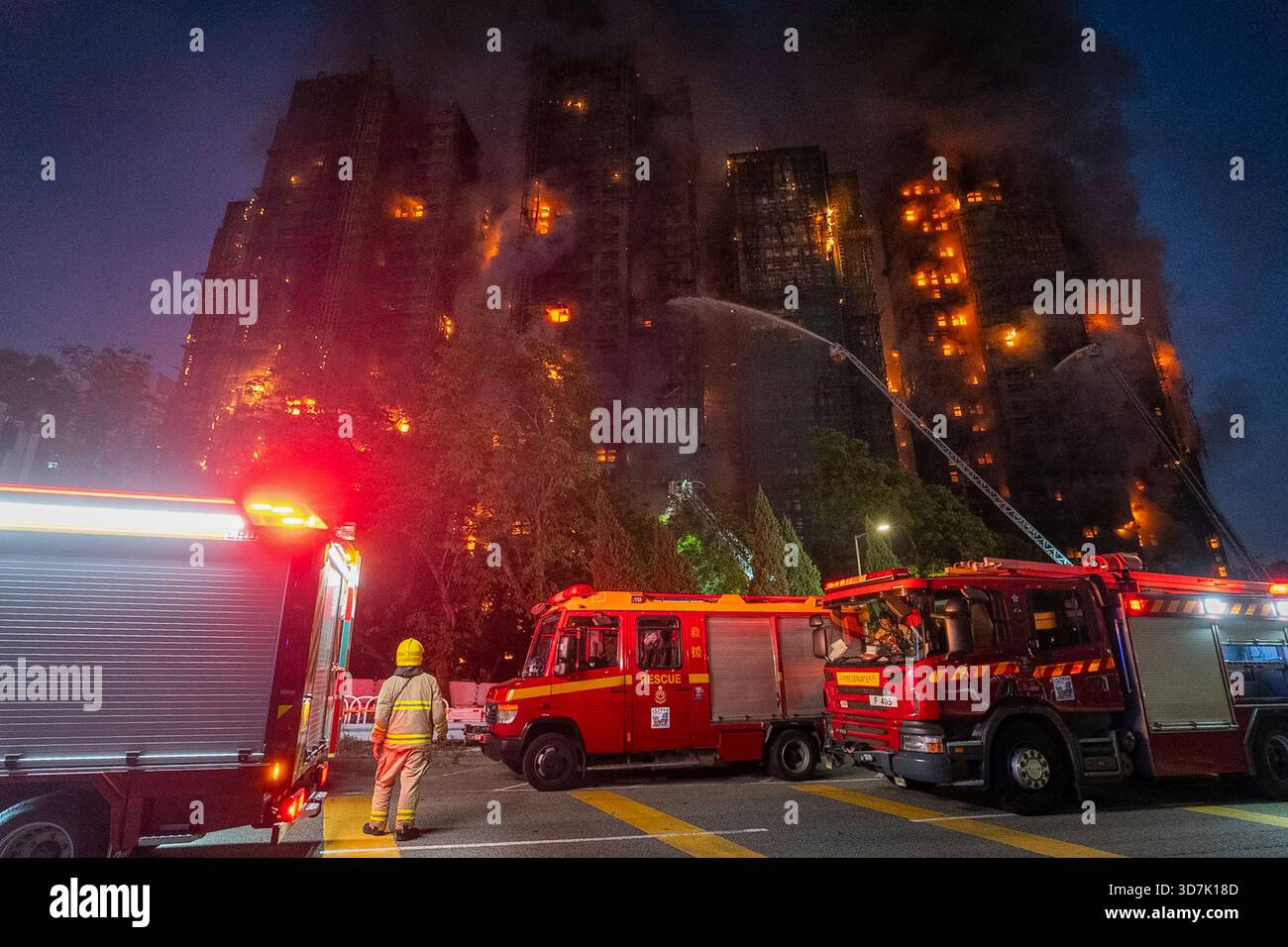 Firefighters work to extinguish a fire which broke out at Wang Fuk ...