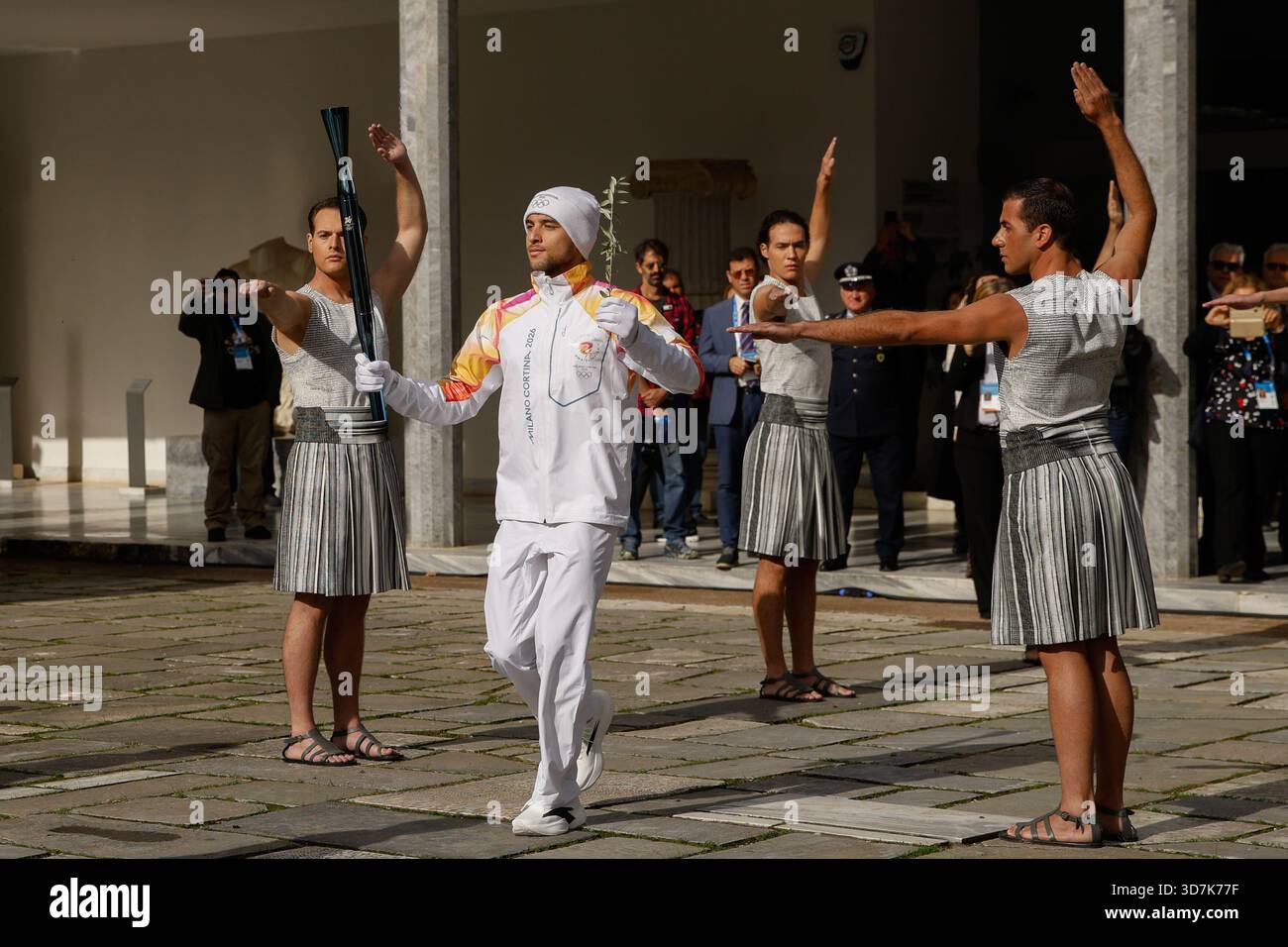 26 November 2025, Greece, Olympia: The first torchbearer Petros ...