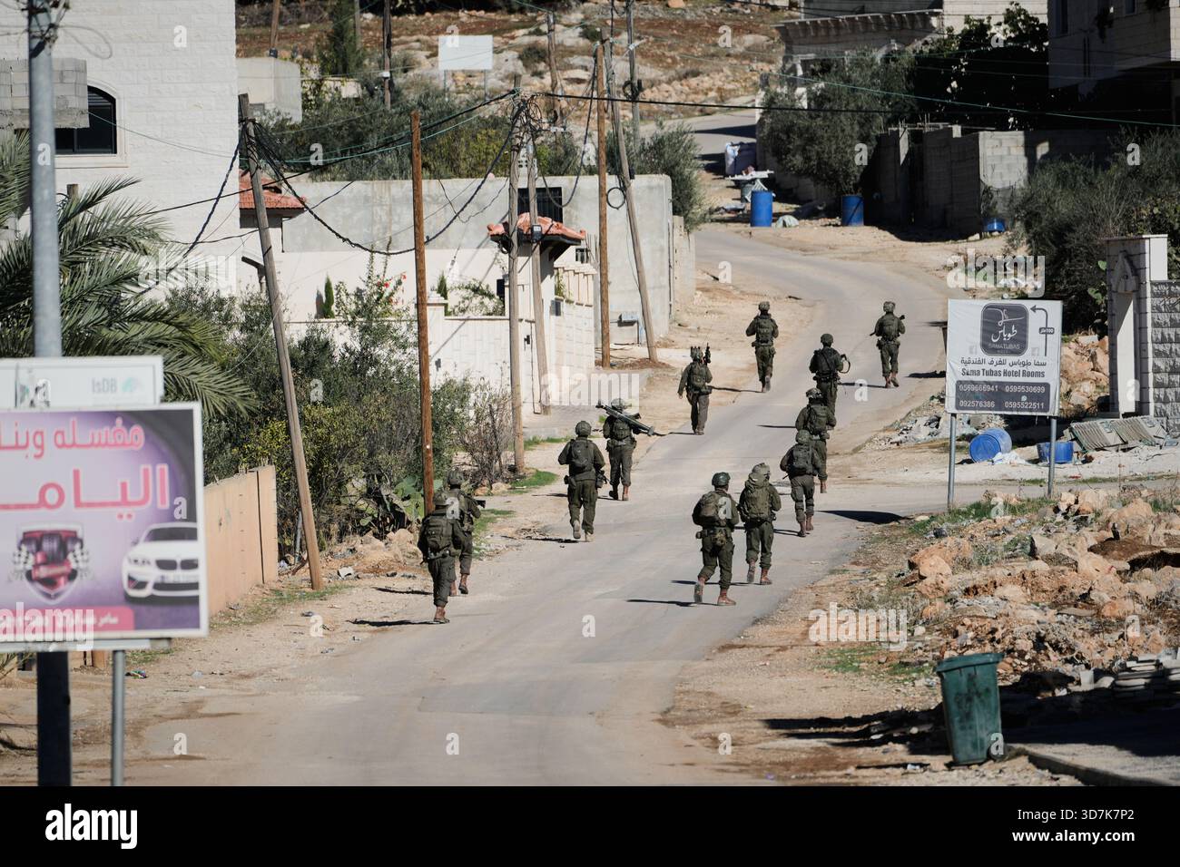 Israeli soldiers are seen during an army raid in the West Bank town of ...