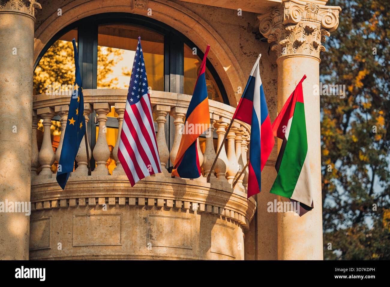 Yerevan Armenia 11.20.2025. A group of flags are hanging from a balcony ...
