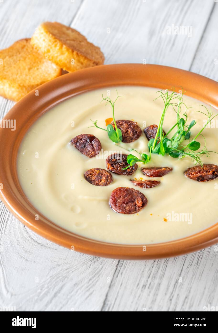 Crisp baguette enhances rich soup as spicy chorizo and sprouts create ...