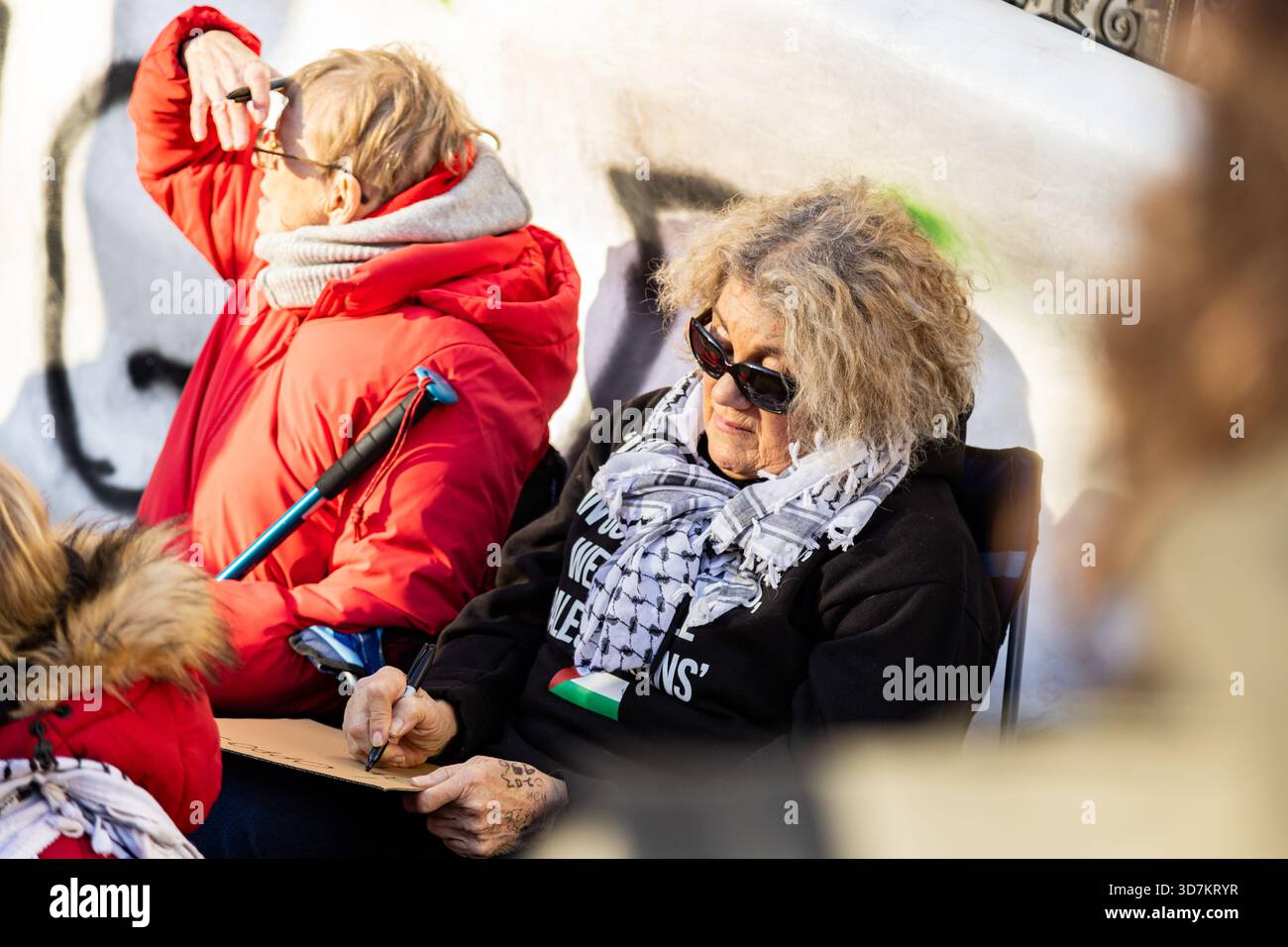 Person writing on placard ahead of the Defend Our Juries protest on the ...