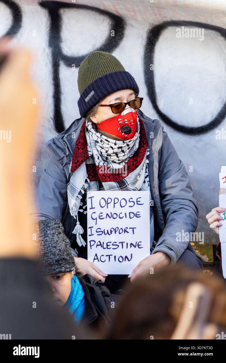 placard being held at Defend Our Juries protest on the ban of Palestine ...
