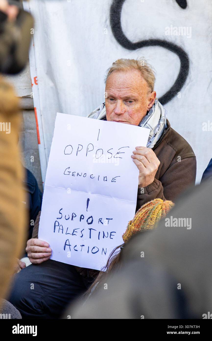 placard being held at Defend Our Juries protest on the ban of Palestine ...