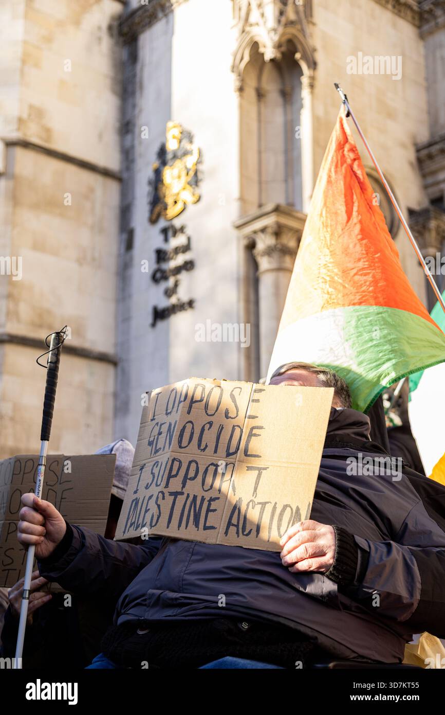 placard being held at Defend Our Juries protest on the ban of Palestine ...