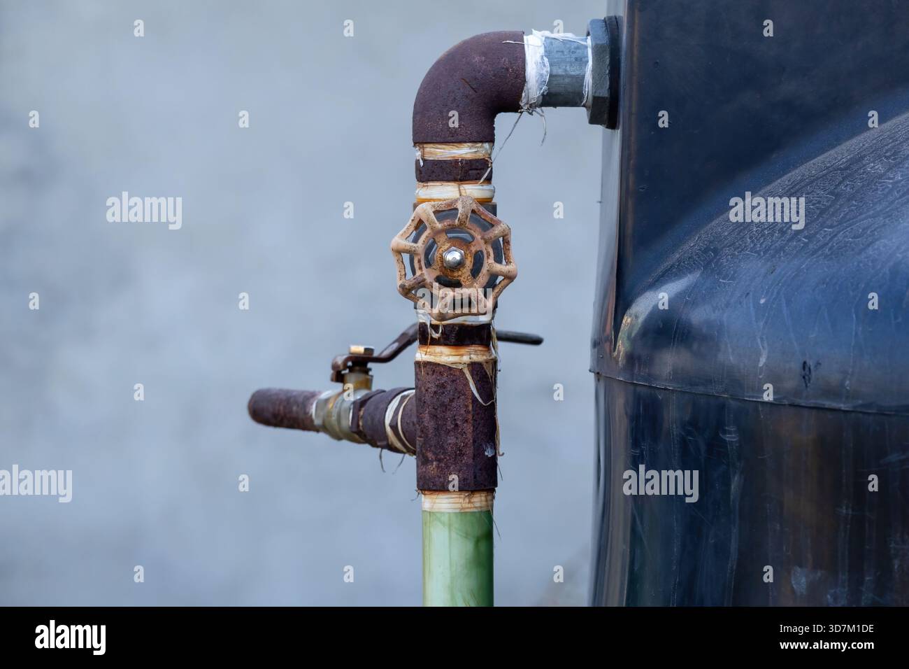 Close-up of a complex water supply system in a Bangladesh home: rusty ...