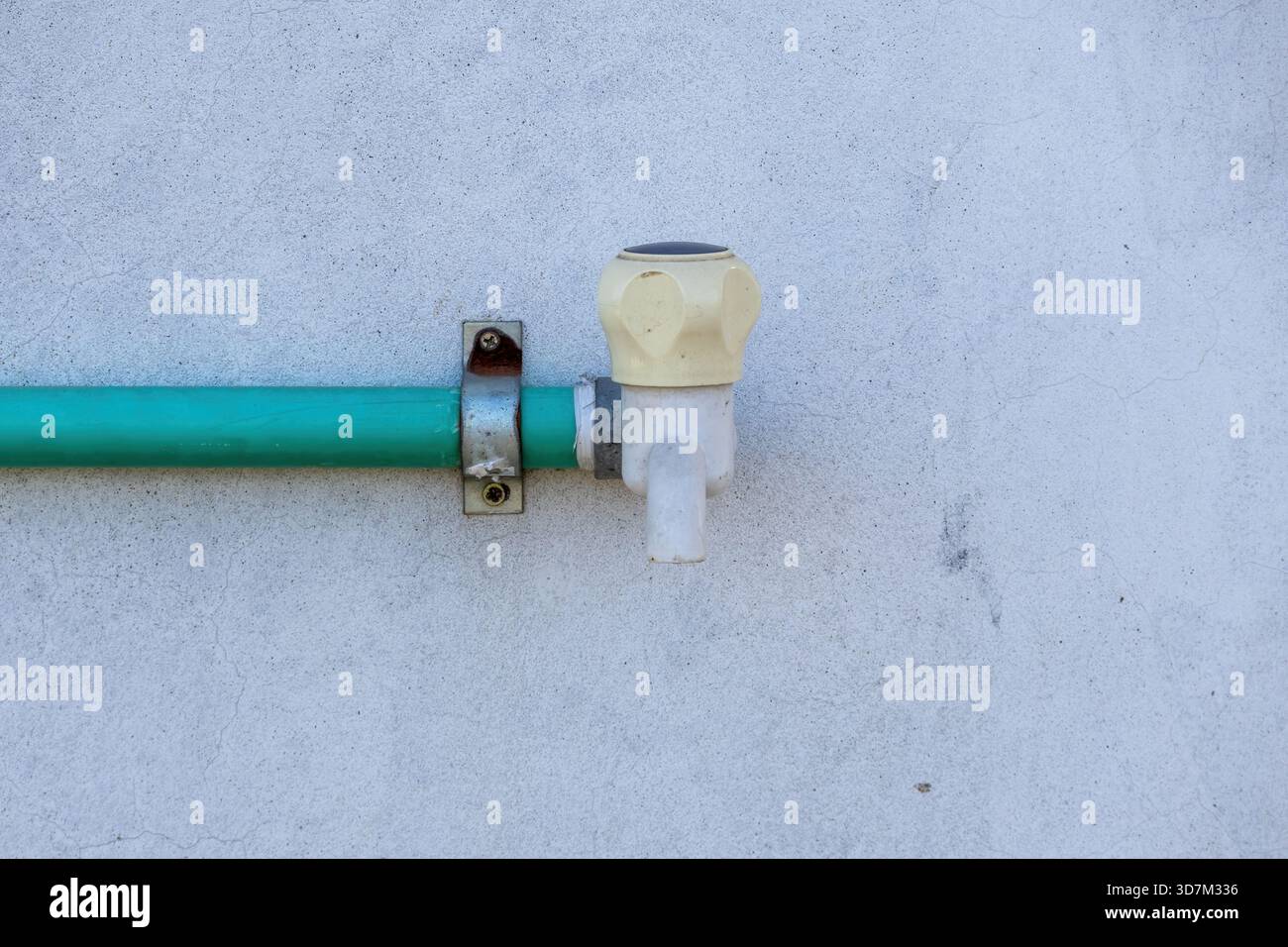 Close-up of a common outdoor plastic water tap (faucet) installed on an ...