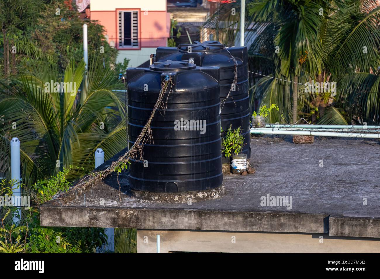 Two typical black plastic tanks mounted on a roof of a residential ...