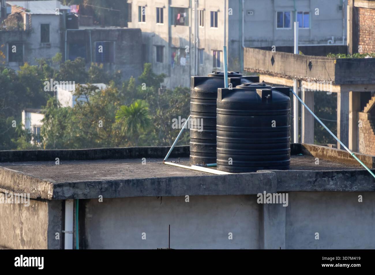 Two black, large plastic water tanks (reservoirs) installed on the ...