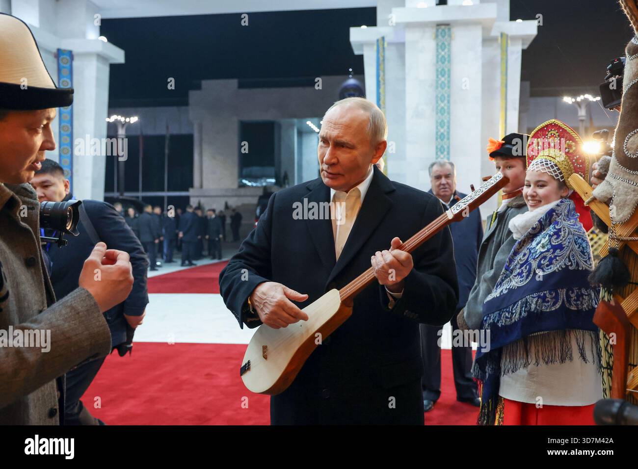 Russian President Vladimir Putin holds a Kyrgyz stringed musical ...
