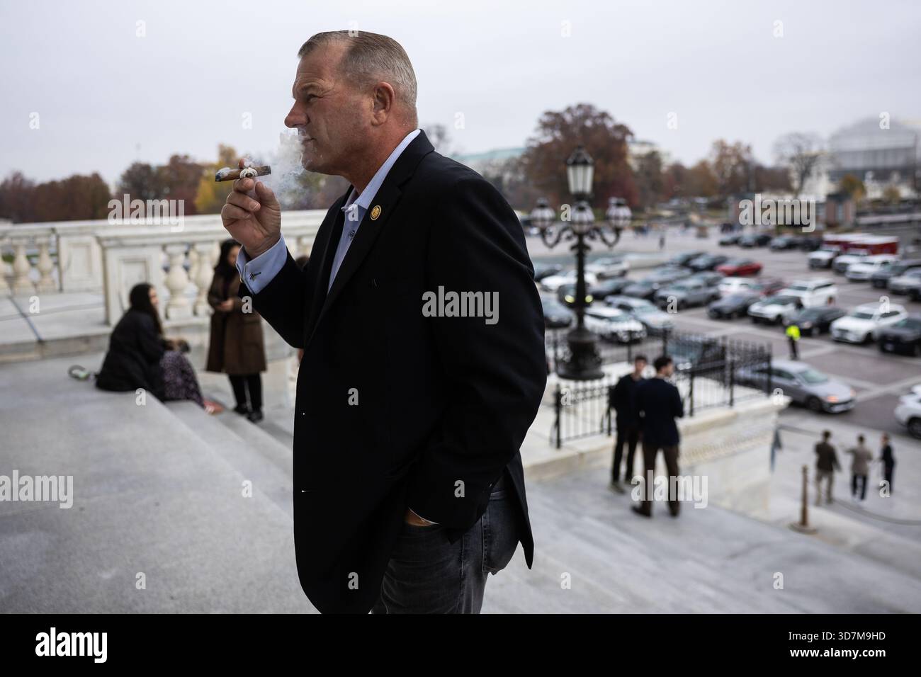 Rep. Troy Nehls (R-Texas) smokes a cigar as he arrives for a vote at ...