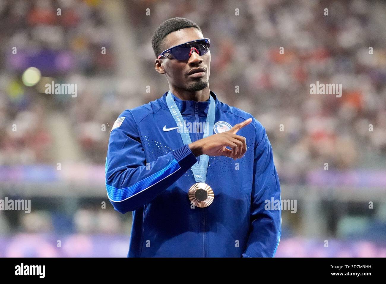 FILE - Bronze medalist Fred Kerley, of the United States, stands on the ...