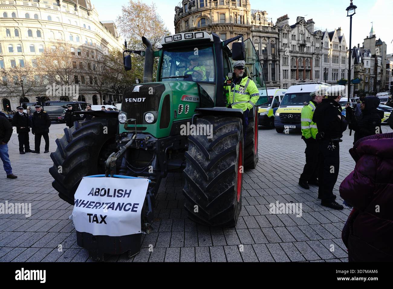 Police officers seize a tractor. Farmers are protesting near Trafalgar ...