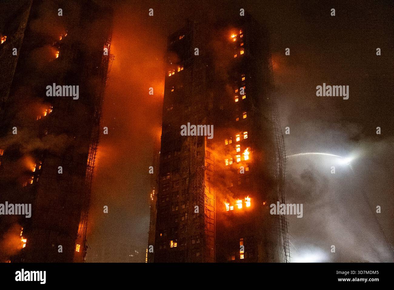 Firefighters try to extinguish a fire that broke out at Wang Fuk Court ...