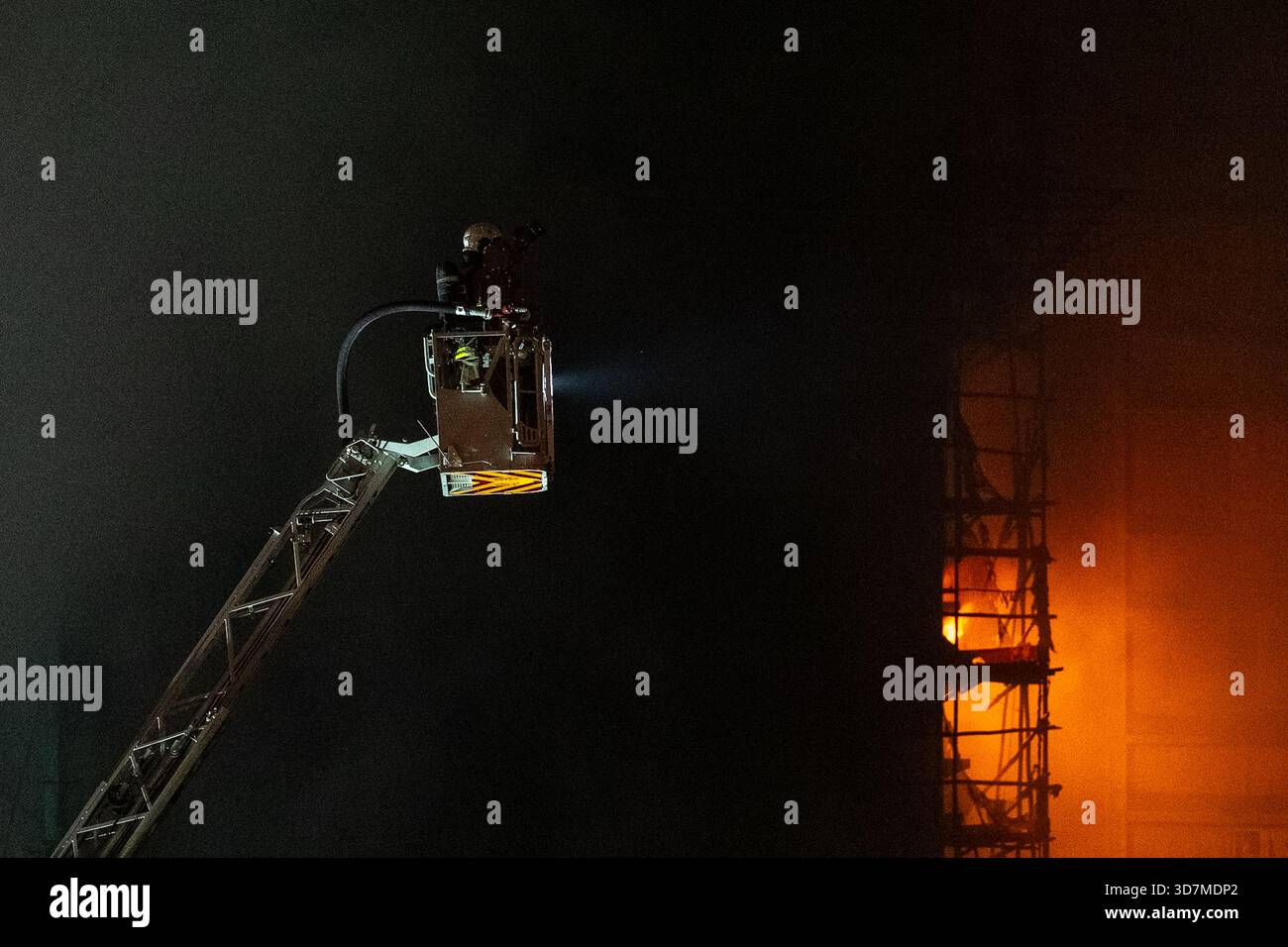 Firefighters work to extinguish a fire that broke out at Wang Fuk Court ...