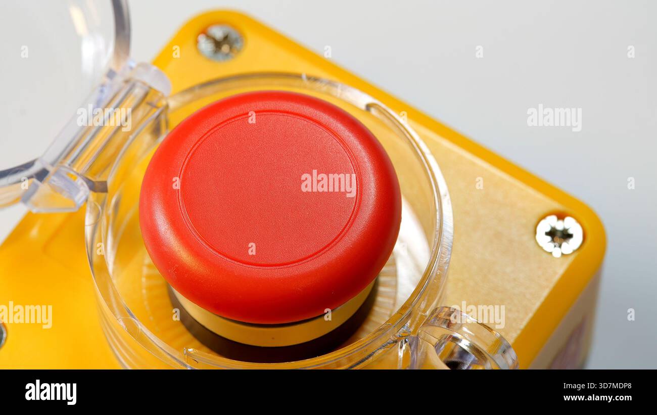 Red emergency stop push button with clear protective cover open ...