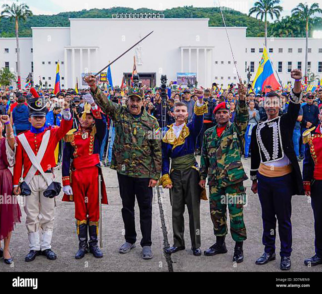 President of Venezuela Nicol‡s Maduro (C) holds the Venezuelan ...