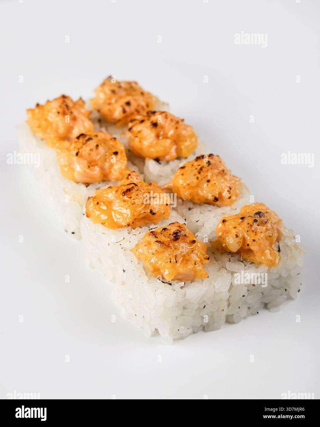 Gourmet baked scallop sushi presented with spicy mayo and peppers Stock ...