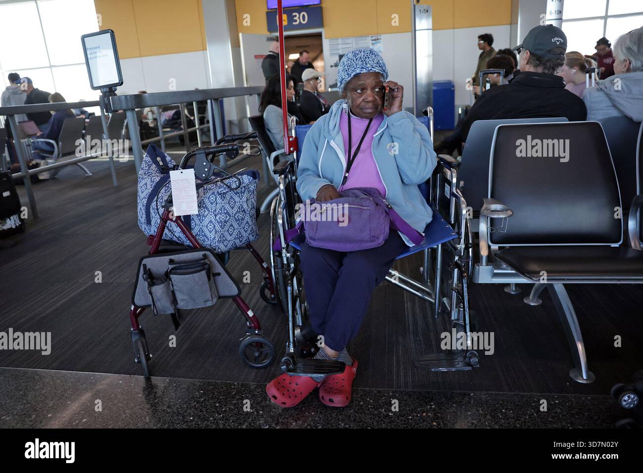 Jean Toney of Oakland waits to board a flight to San Diego to visit ...