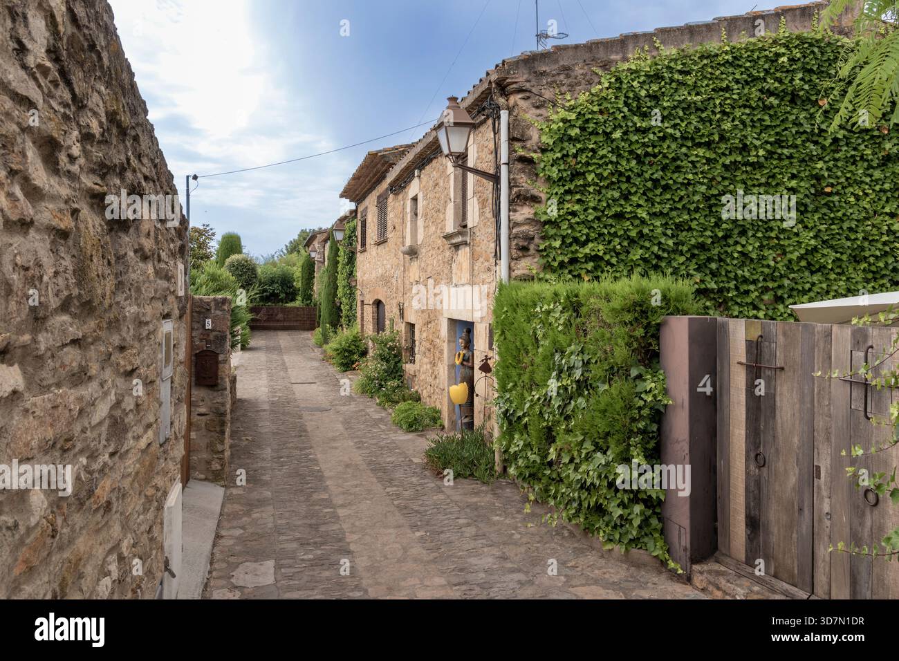 Cobblestone alley winding between ancient stone houses in the historic ...
