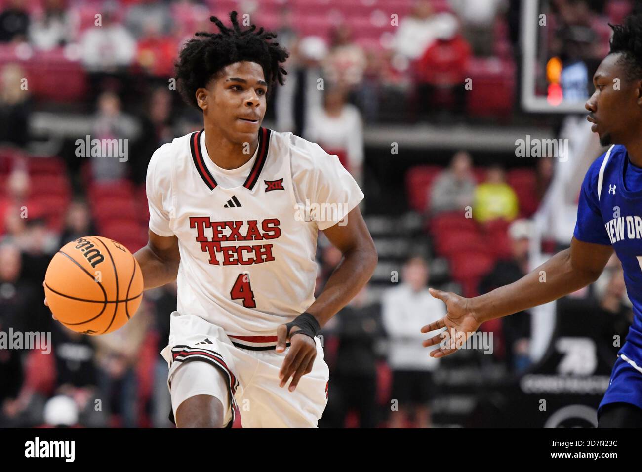 Texas Tech guard Christian Anderson (4) dribbles the ball during the first half in an NCAA ...