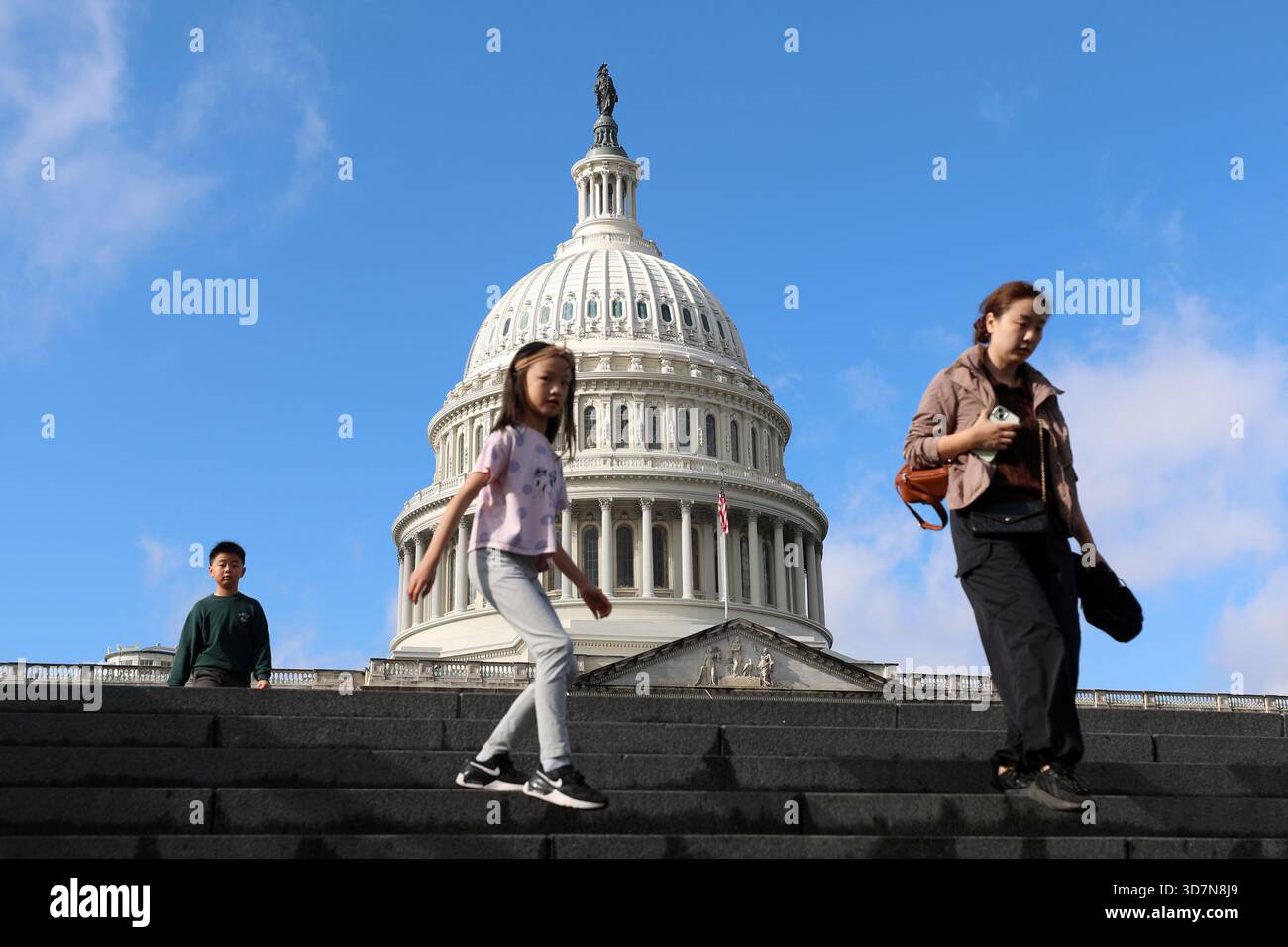 Visitors walk the steps in front of the the U.S. Capitol, Wednesday ...