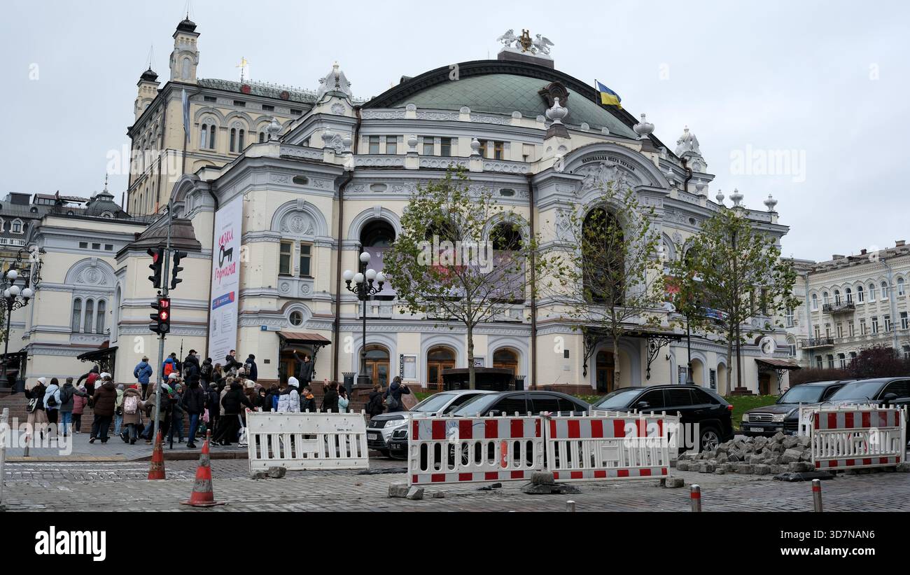 People gather outside a grand theater, admiring its architecture in the ...