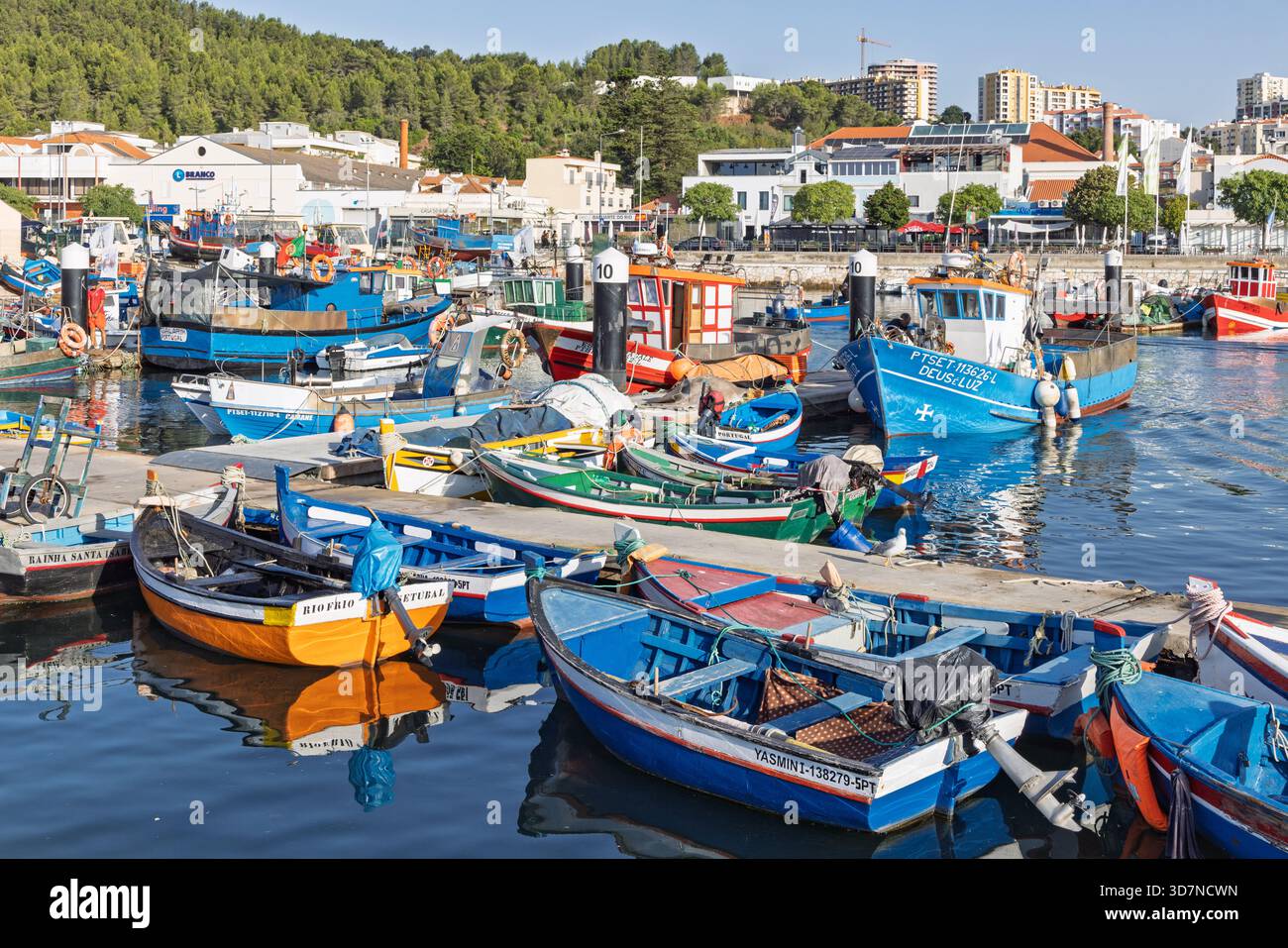 Wide view of the bustling fishing harbor of Setubal, Portugal, filled ...