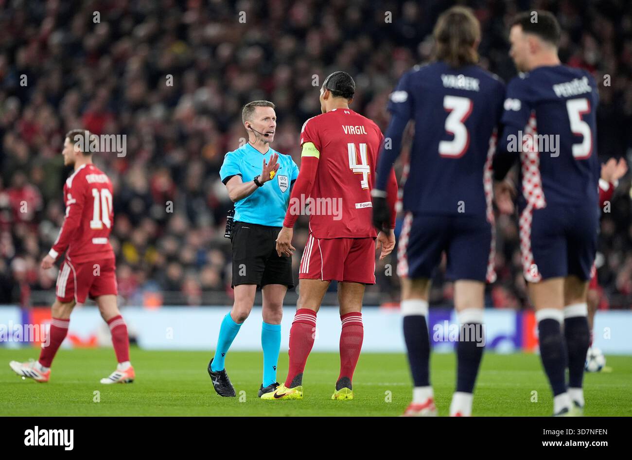 Liverpool's Virgil van Dijk (centre) speaks to Referee Alejandro ...