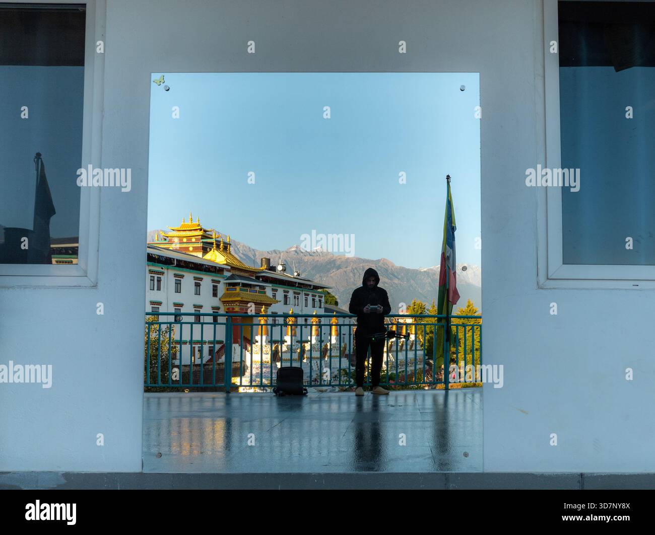 Aerial view of a person standing in front of the serene, white-walled ...