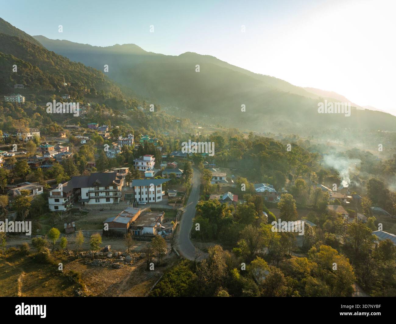 Aerial view of a winding road cutting through the village nestled on ...