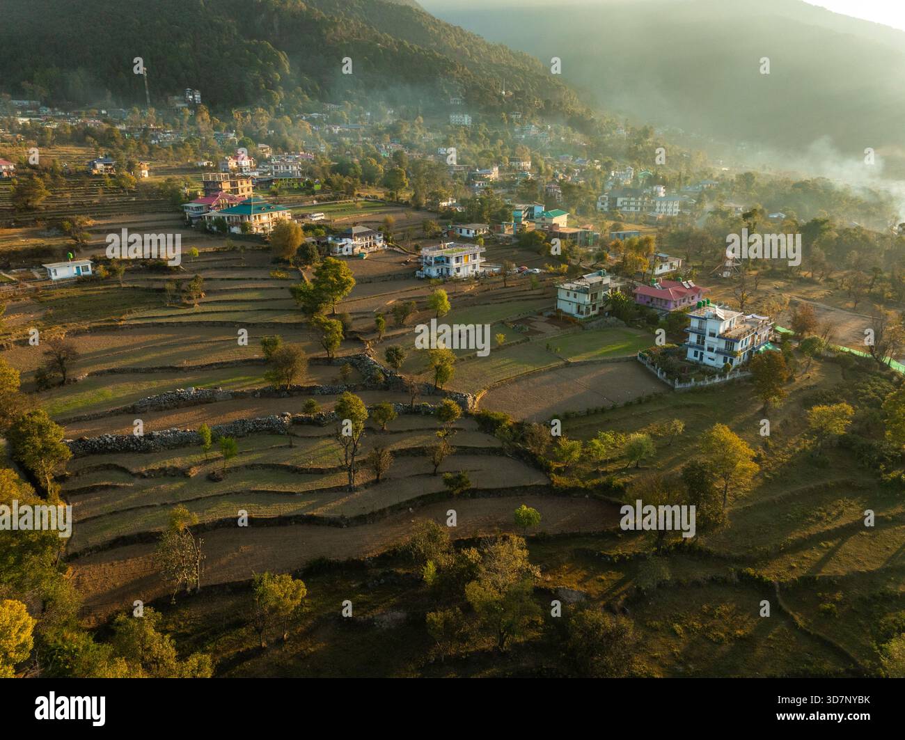 Aerial view of terraced fields cascading down to meet the village homes ...