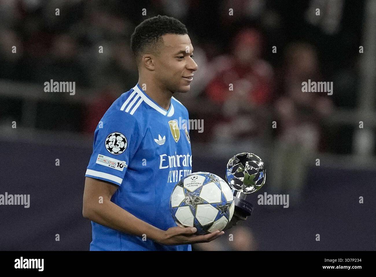 Real Madrid's Kylian Mbappe poses with the trophy after scoring four ...