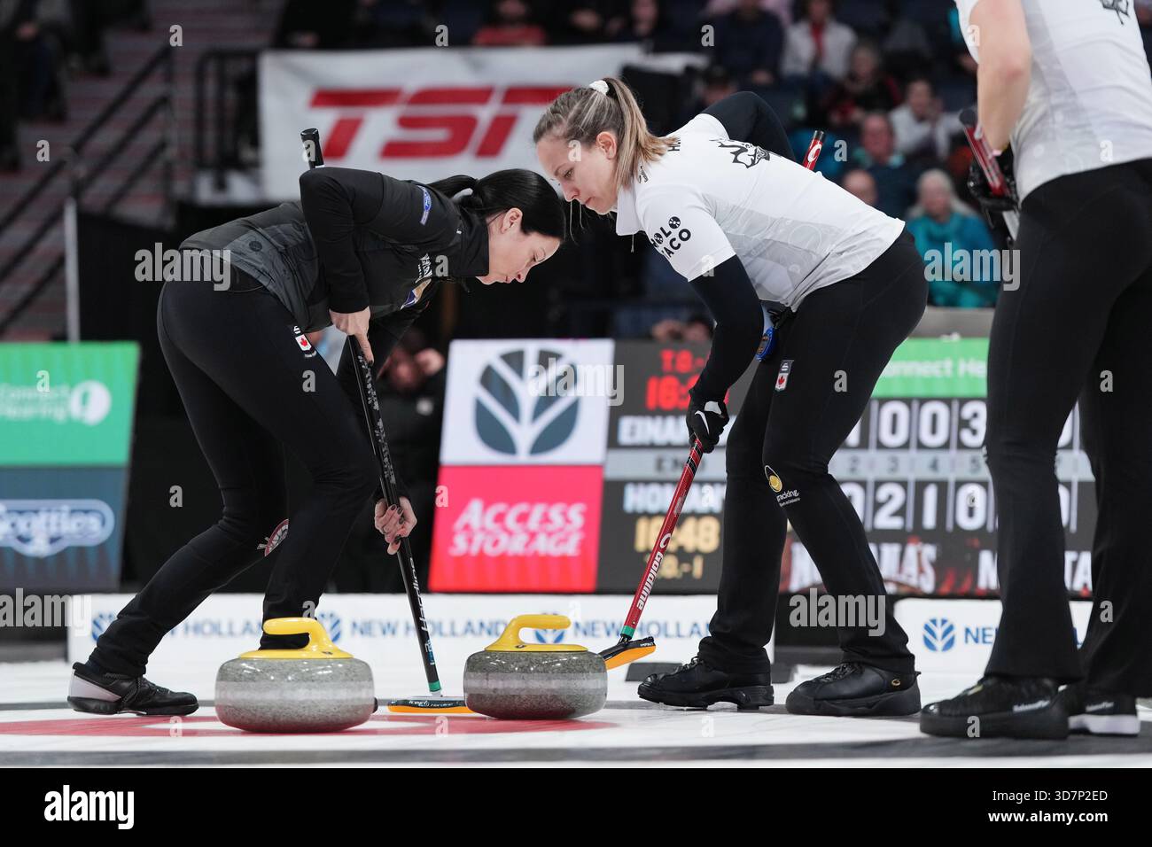 Rachel Homan, right, and Kerri Einarson sweep stones in the house ...