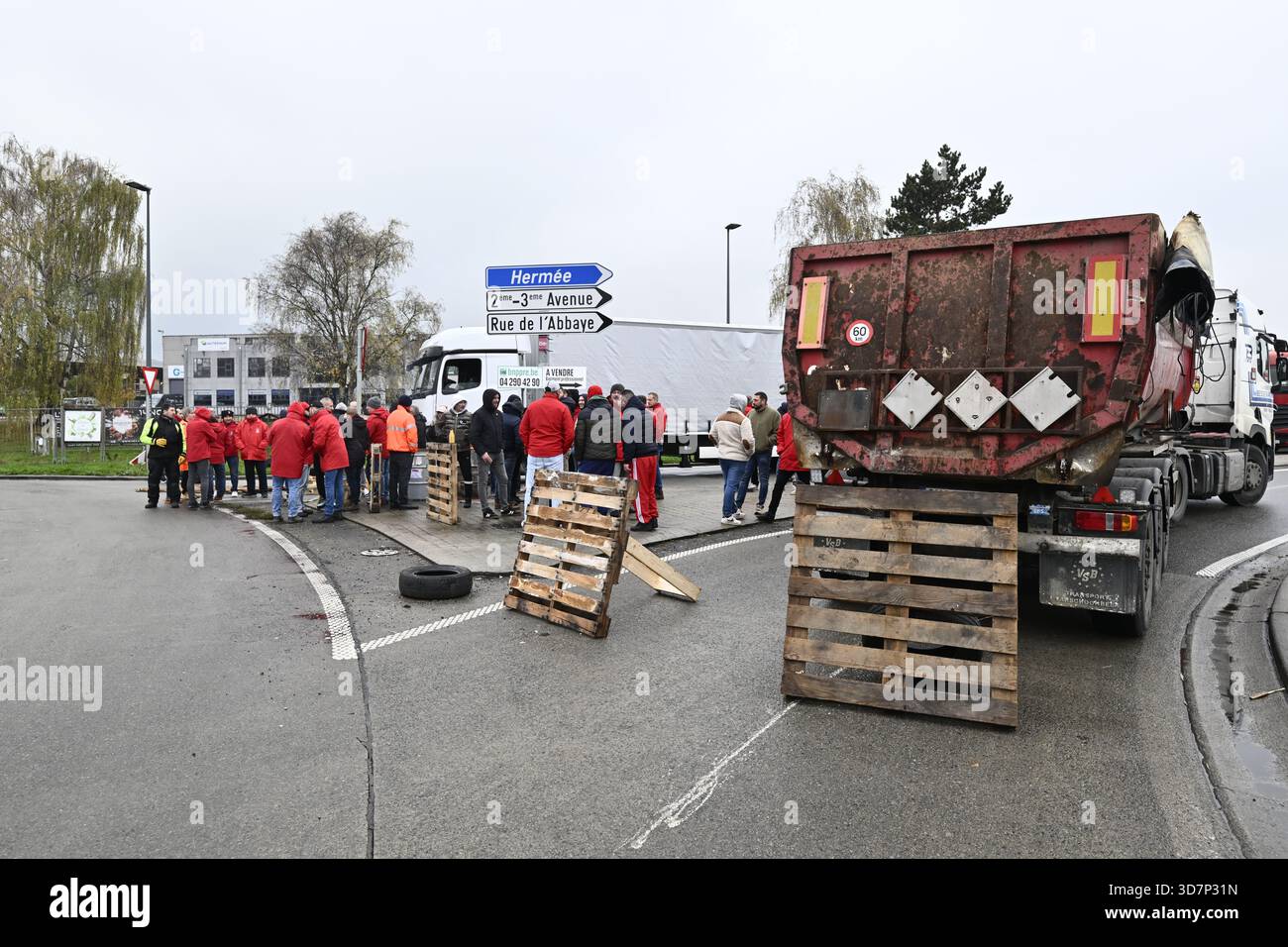 Strikers form a picket line at the Hauts-Sarts industrial zone in ...