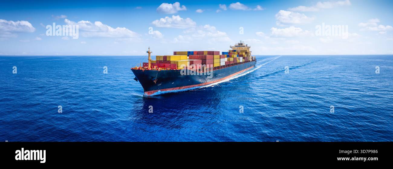 Panoramic aerial view of a loaded container cargo carrier ship sailing ...