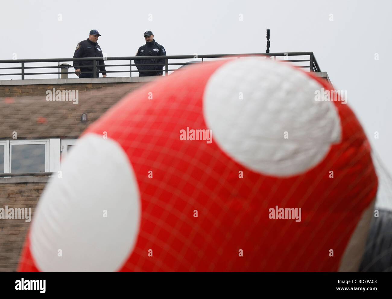 NYPD police officers stand on a roof near where the Disney Minnie Mouse ...