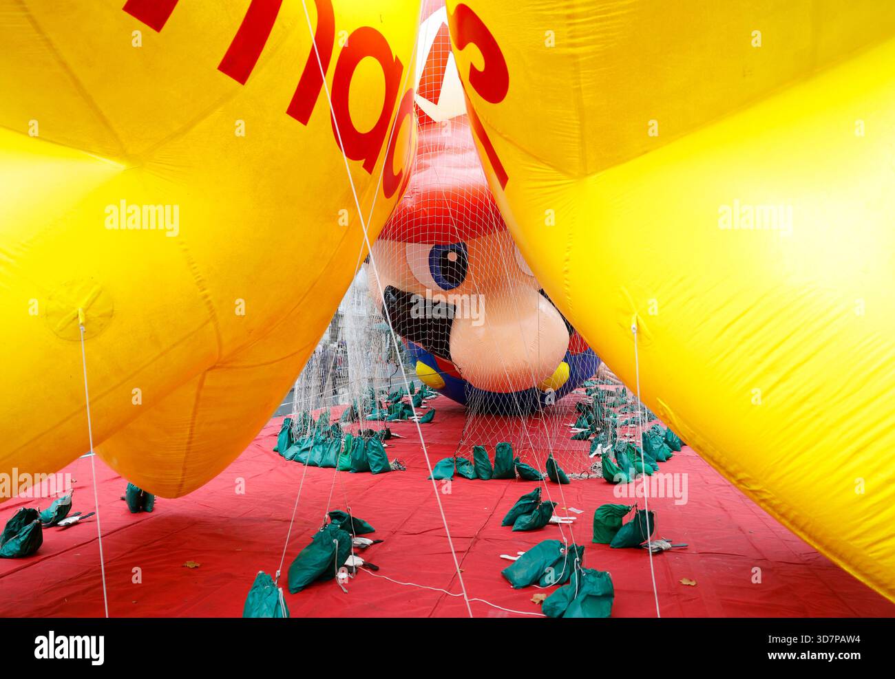 The Mario Balloon is held under a net on the eve of the 99th Macy's ...